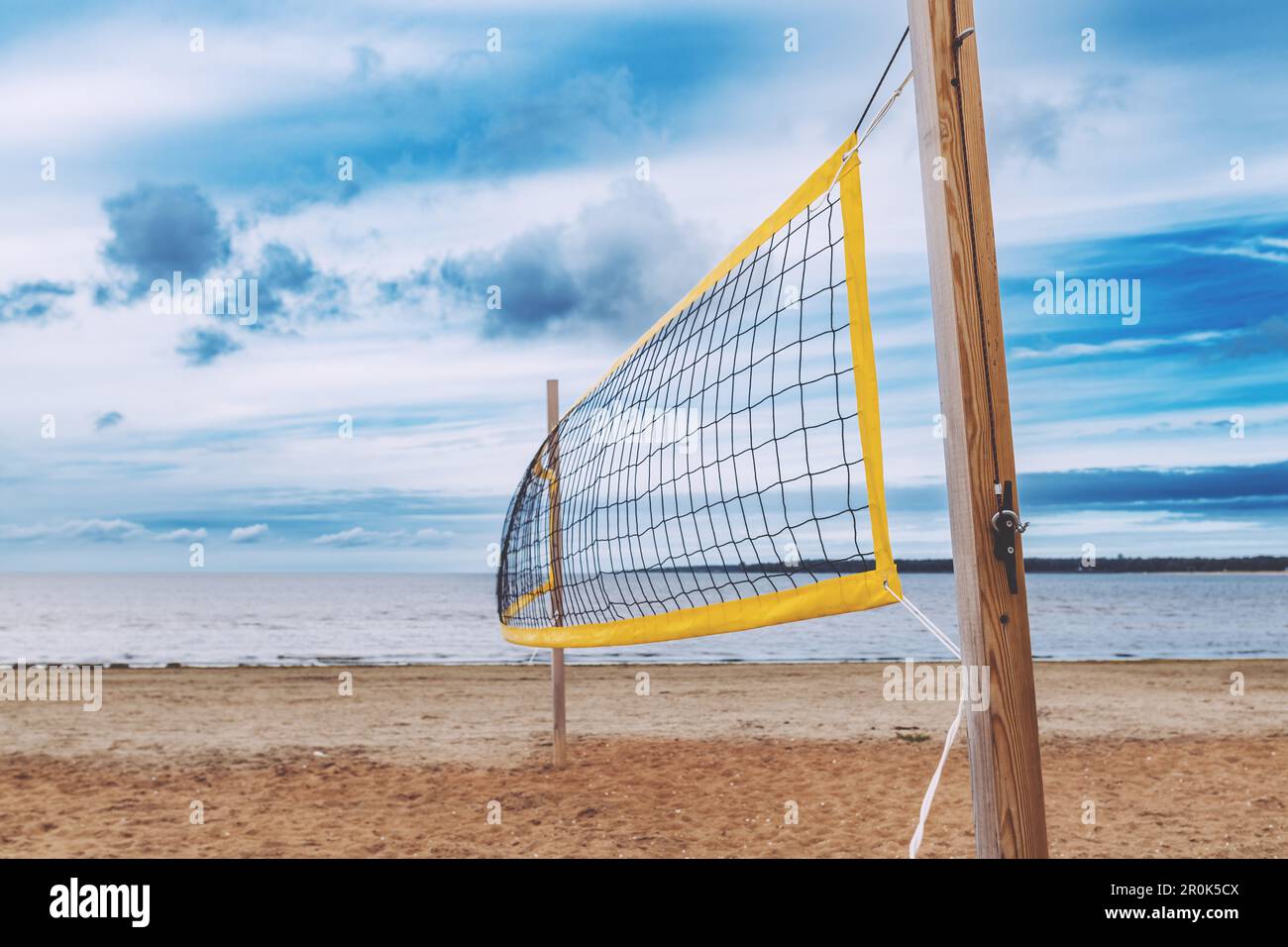 Beach volleyball net on sandy terrain of Halmstad West beach on overcast summer day, selective ...