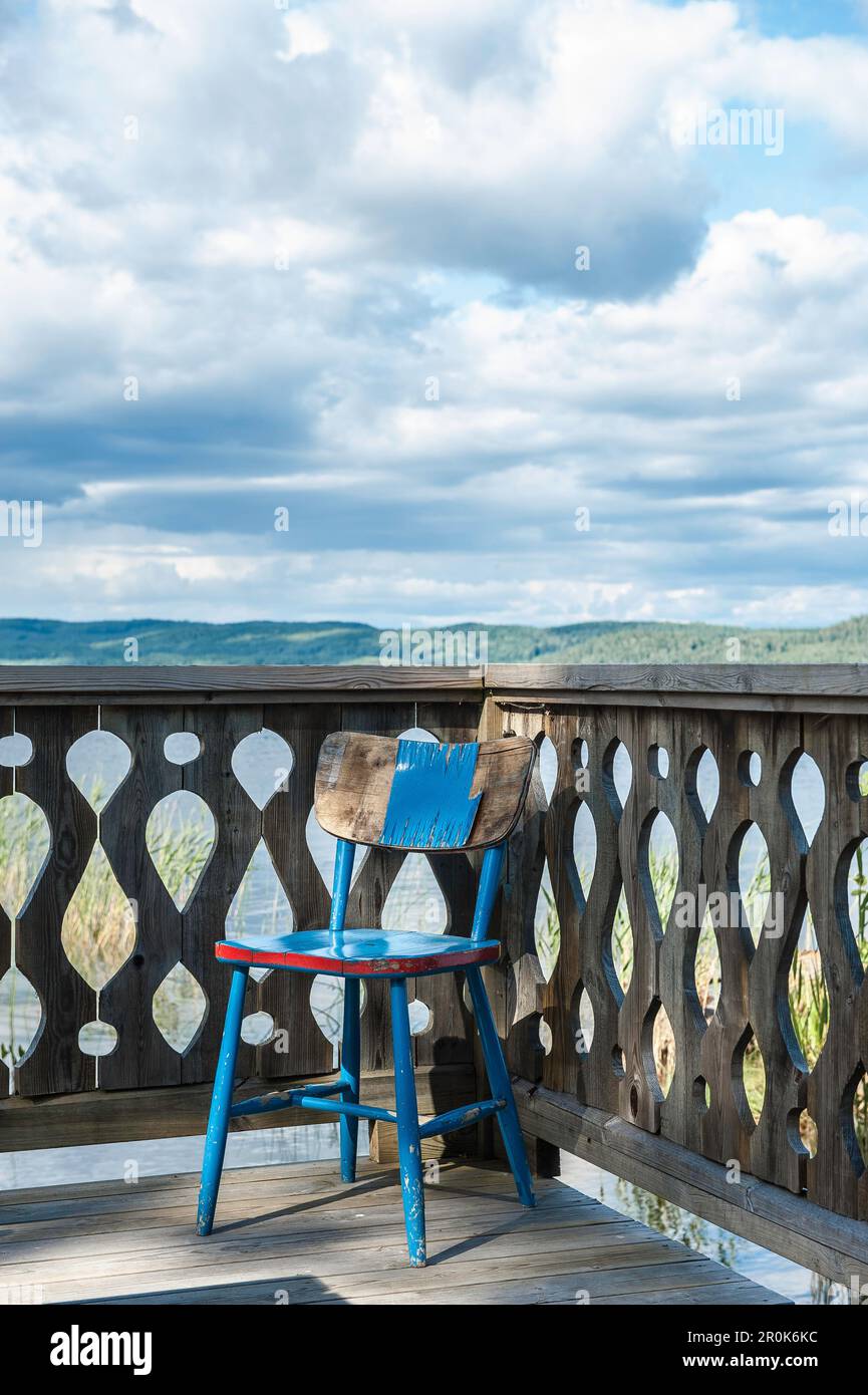 old chair on the veranda at the border of lake Siljan, Solleron ...