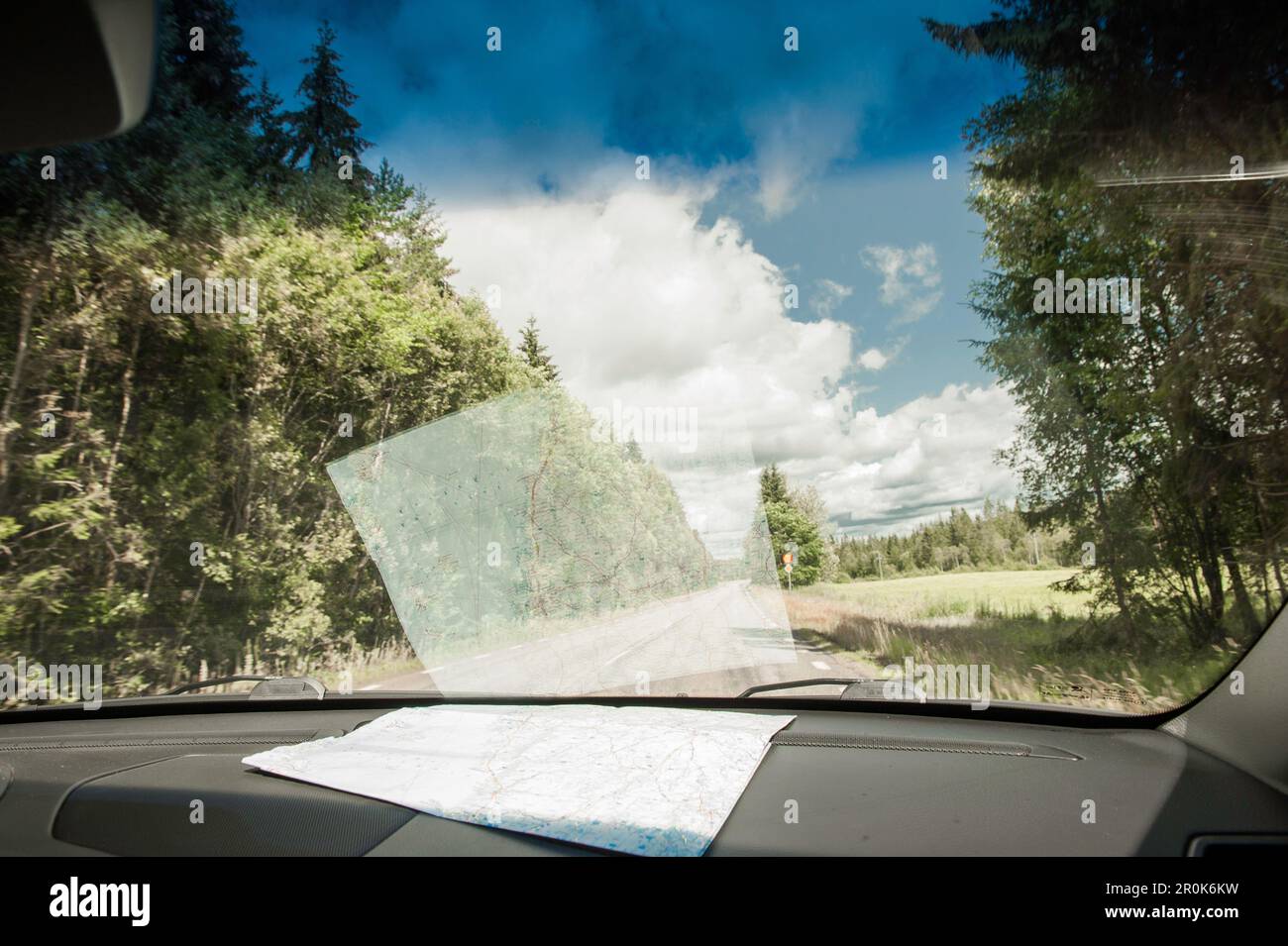 Looking through the front window of the car with the map on the dash ...