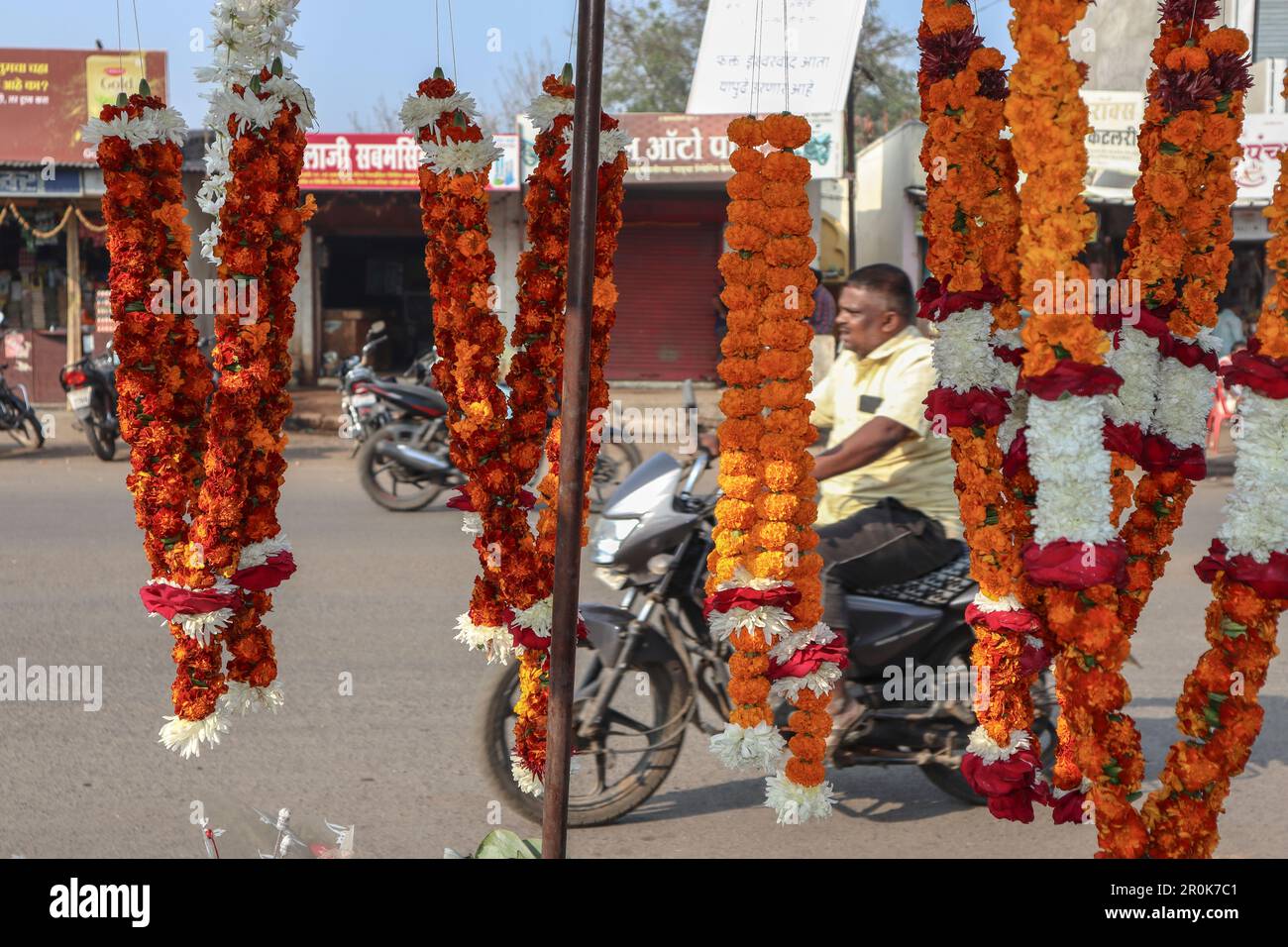 Flower garlands made of Marigold flowers and rose flowers hanging in ...