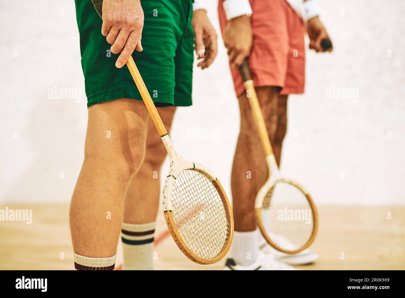 The type of racket makes all the difference. two men holding their ...