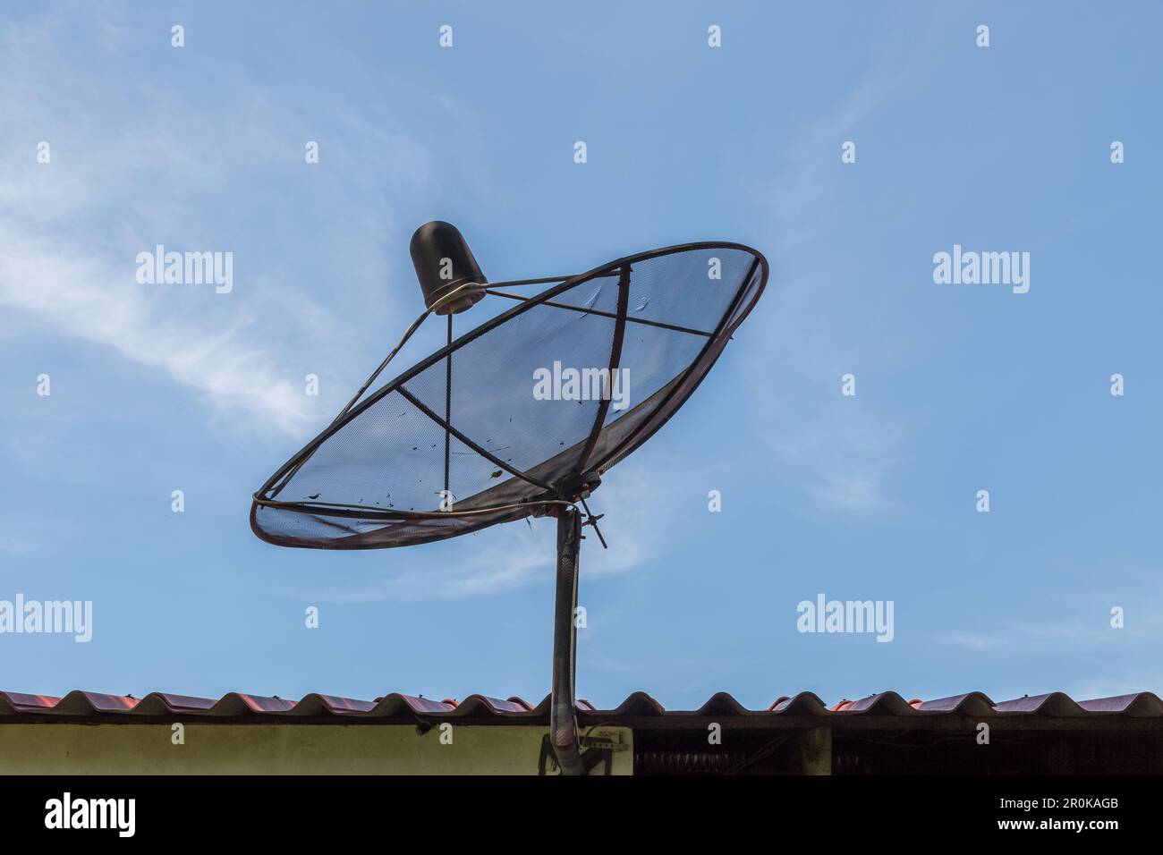 Old satellite dish on blue sky baclground Stock Photo - Alamy