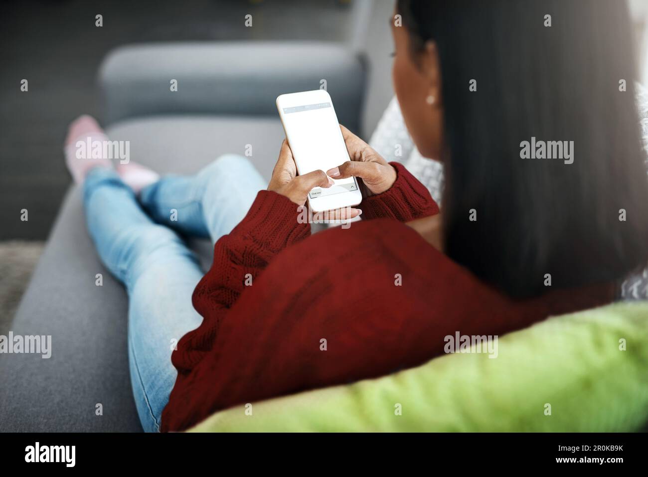 Woman, phone screen and typing on home sofa to relax with internet ...