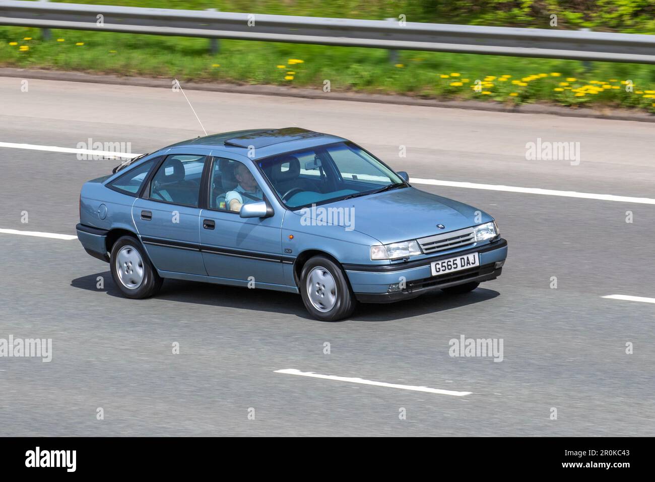 1990 90s nineties Blue VAUXHALL CAVALIER CDi; travelling on the M61 ...