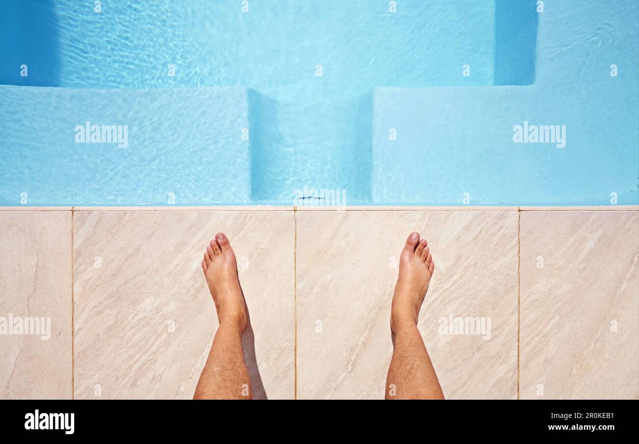 Water, feet and pov of man at a pool for swimming, leisure and summer ...