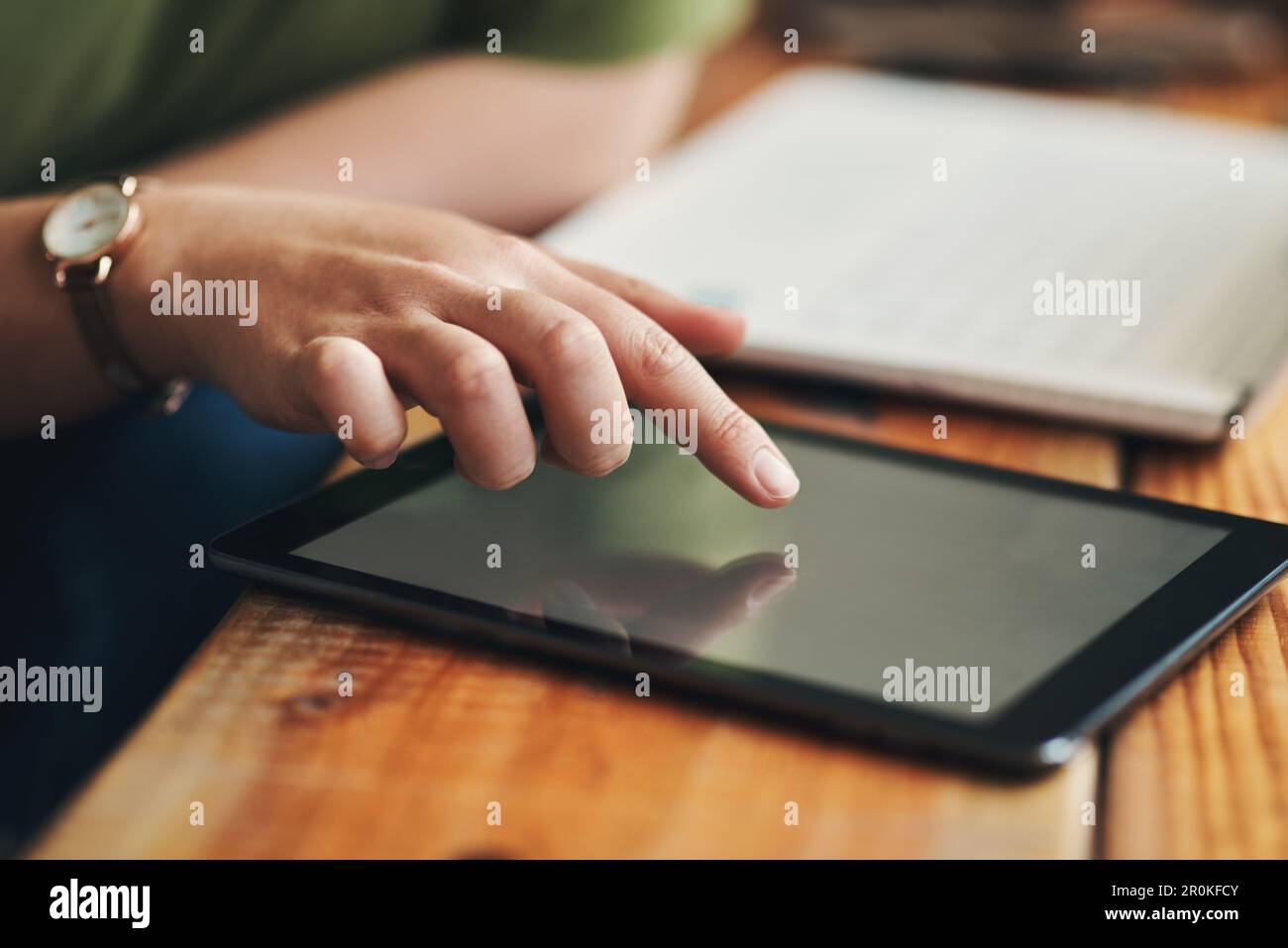 Tapping the way to a completed task. a woman using a digital tablet ...