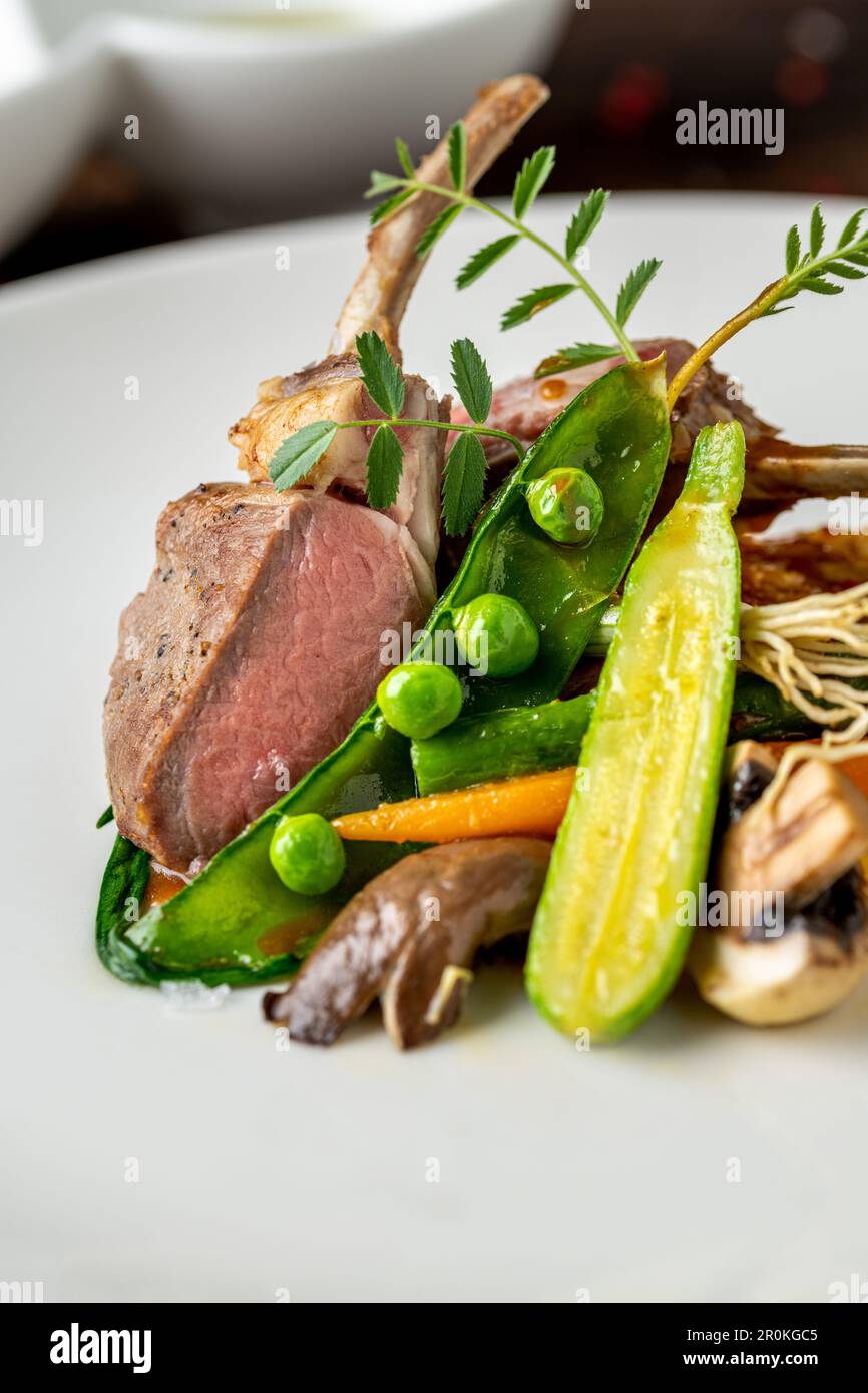 lamb chops with various vegetables at a fine dining restaurant Stock ...