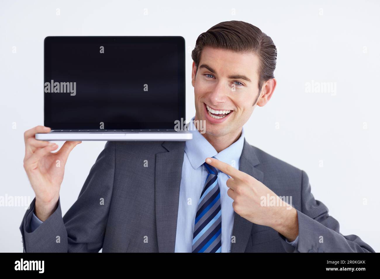 Mockup, laptop and business man portrait pointing to screen space ...