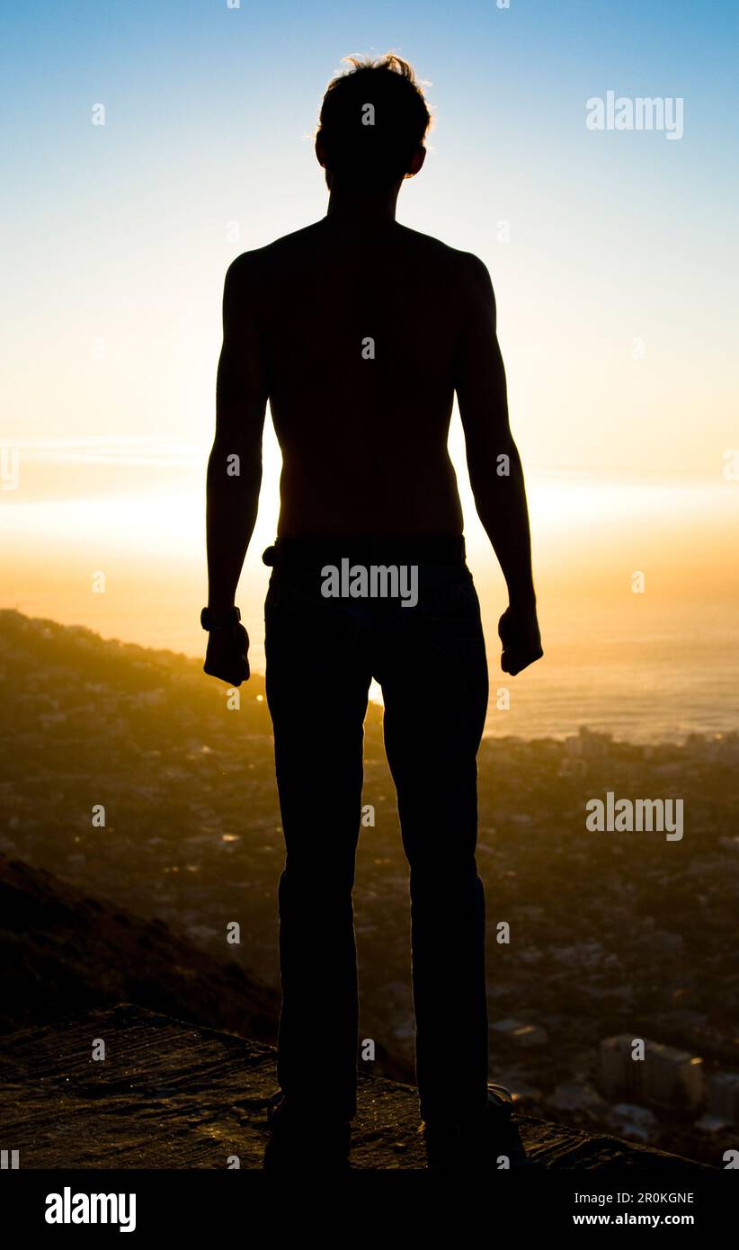 Man, silhouette and mountain in sunset for achievement, adventure or ...