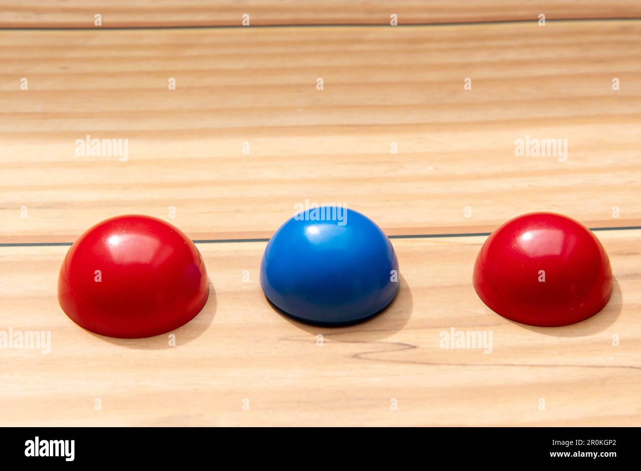three half balls on wooden base in the colours red and blue Stock Photo ...