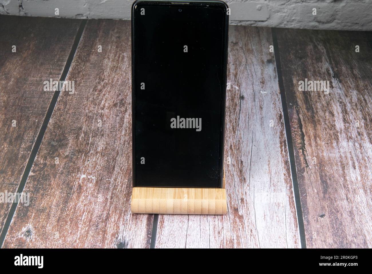 Mobile phone with dark empty Handydispaly for text free space on wooden ...