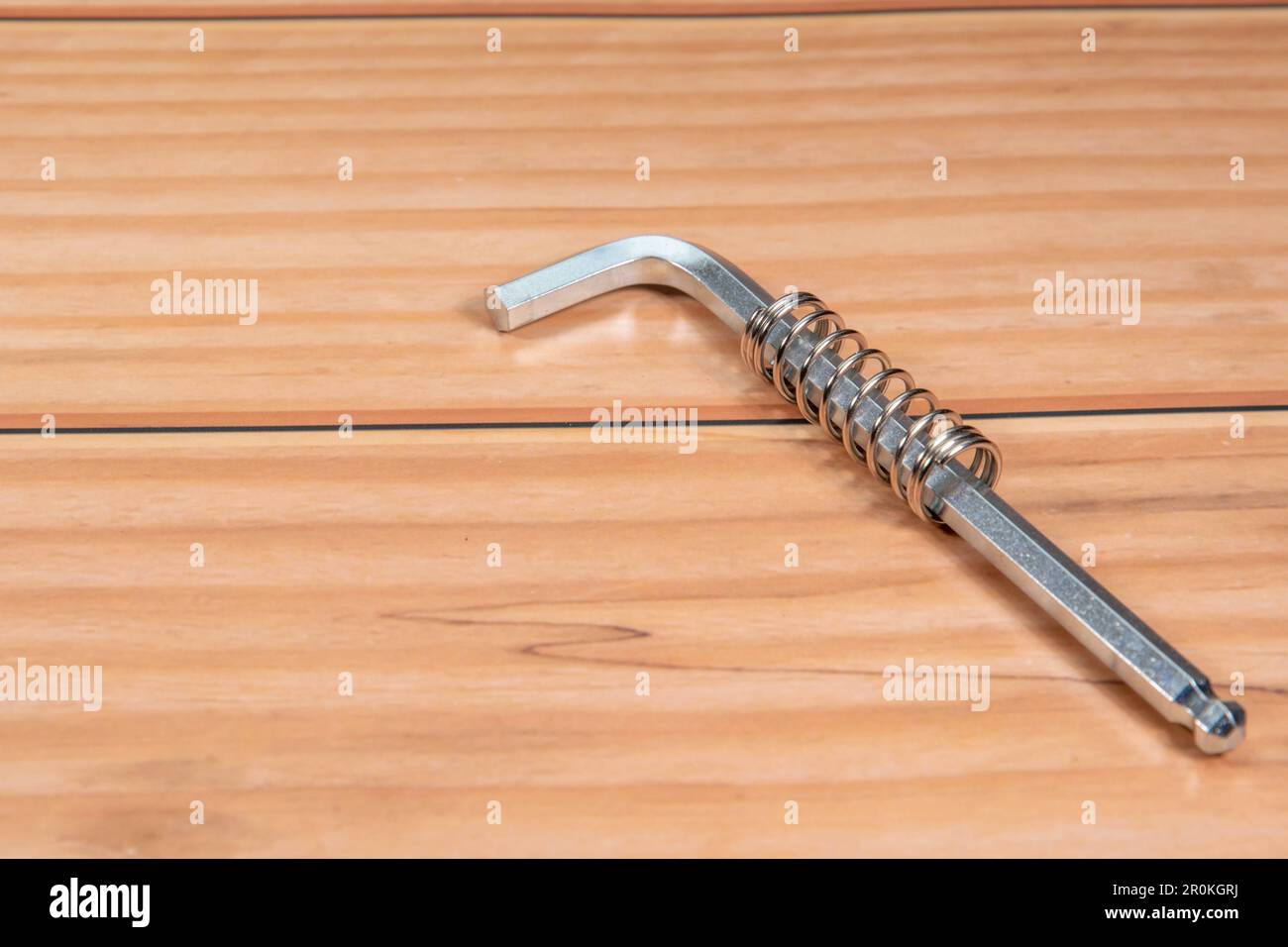 Spiral spring on an Allen key with text free space on wooden base Stock ...