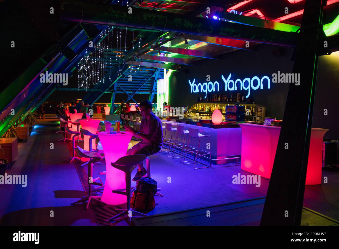People relax at Yangon Yangon Rooftop bar at top of Sakura Tower at night, Yangon, Yangon ...