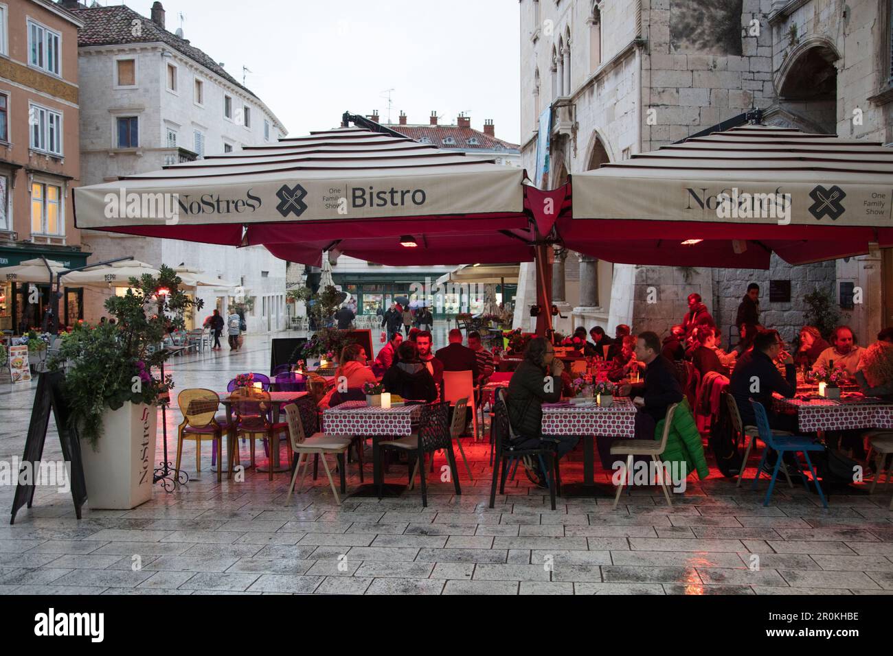 People sit underneath heat lamps outside No Stress Bistro and enjoy ...