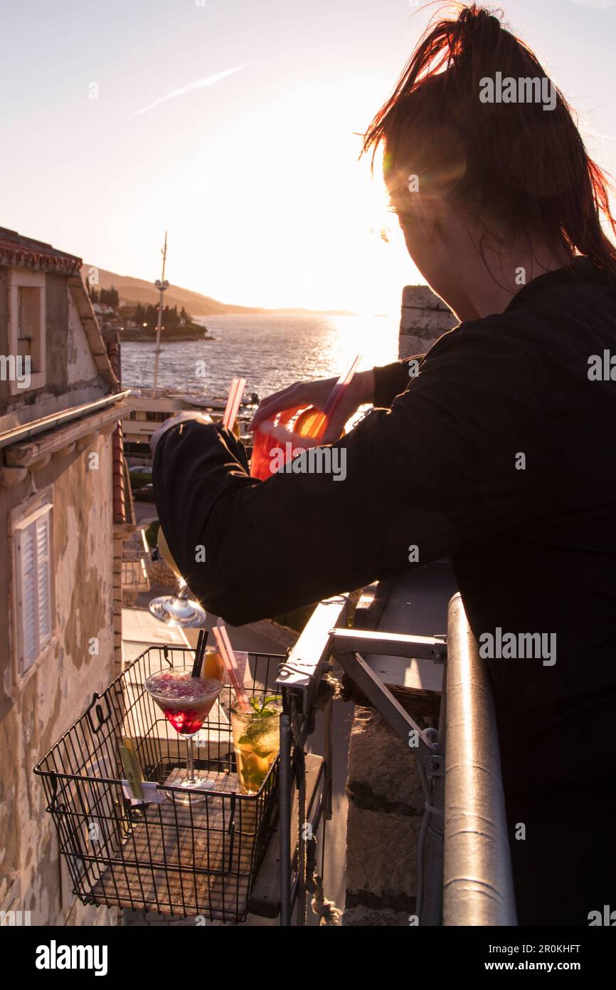 Waitress with tray of drinks that were lifted with pulley from bar to ...