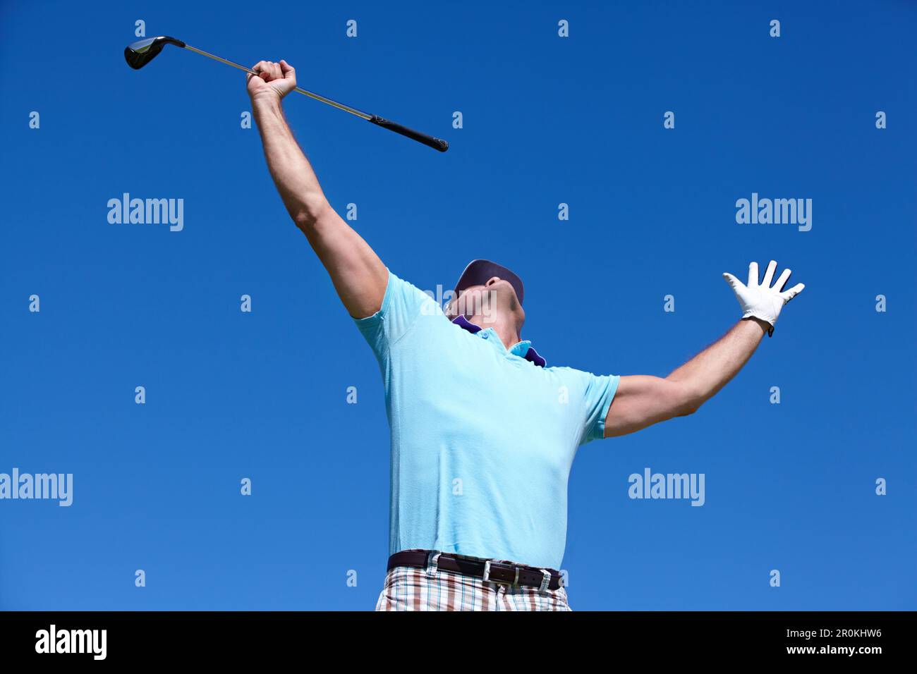 Golf, winner and man with hands up in celebration on blue sky ...