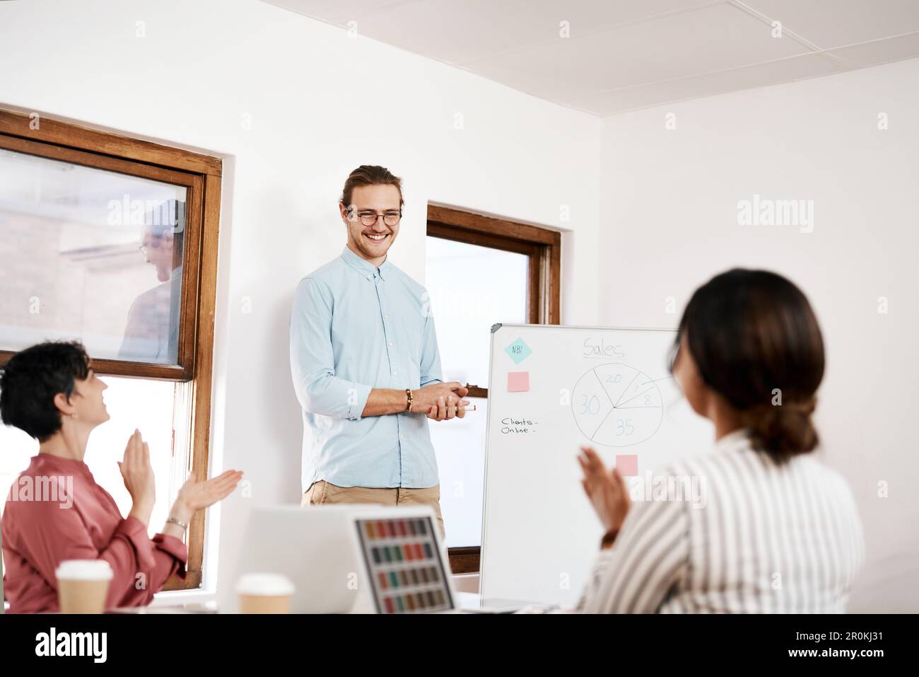 Thank you. a handsome young businessman standing and writing on a white ...