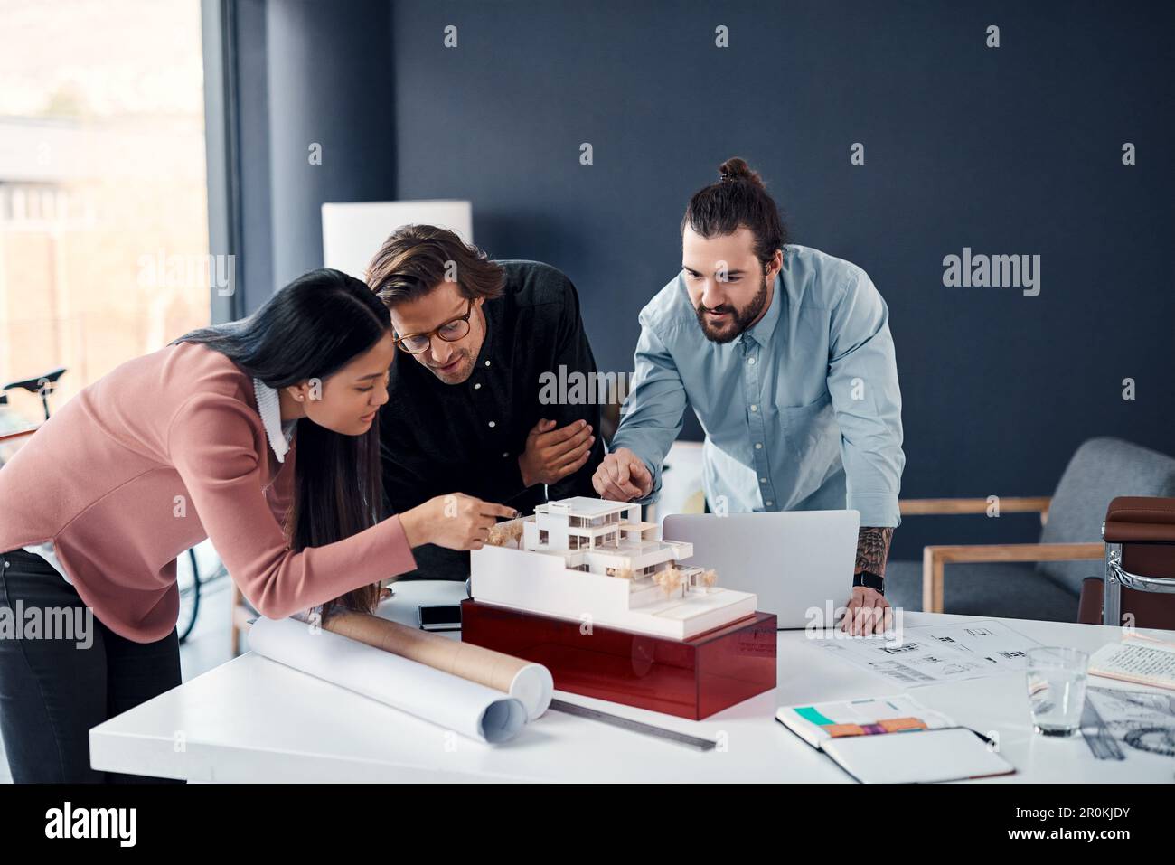 She always spots the tiniest of details. three young architects working ...