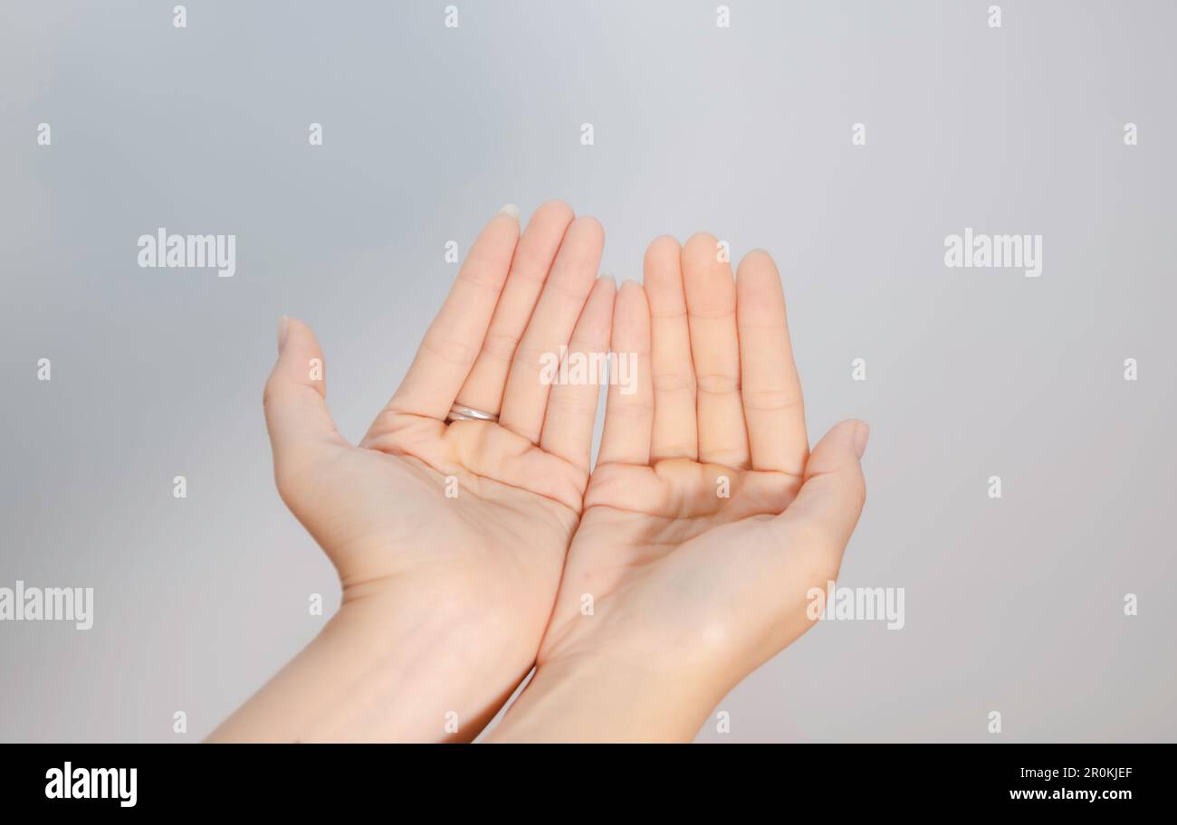 two empty female beautiful hands open with palms up closeup of top view ...