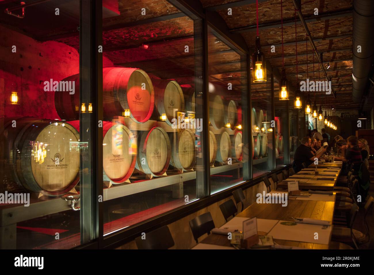 Wooden barrels used for craft beer on display and tables at Liebesbier ...