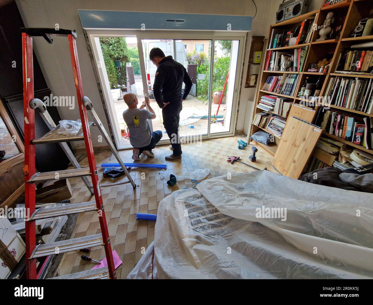 Interior fittings, craftmen setting up a glass window, Bron, France ...