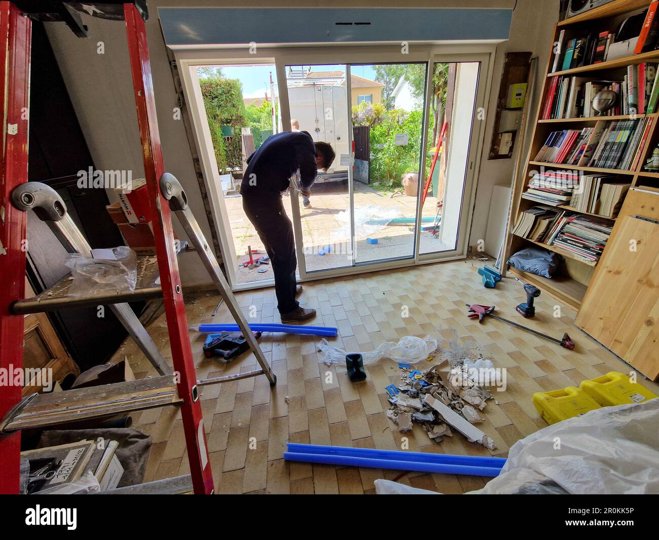Interior fittings, craftmen setting up a glass window, Bron, France ...