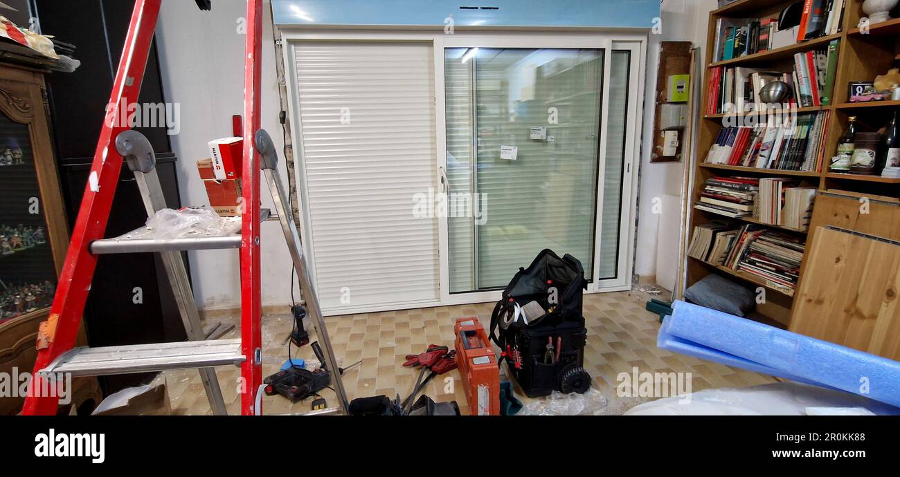 Interior fittings, craftmen setting up a glass window, Bron, France ...