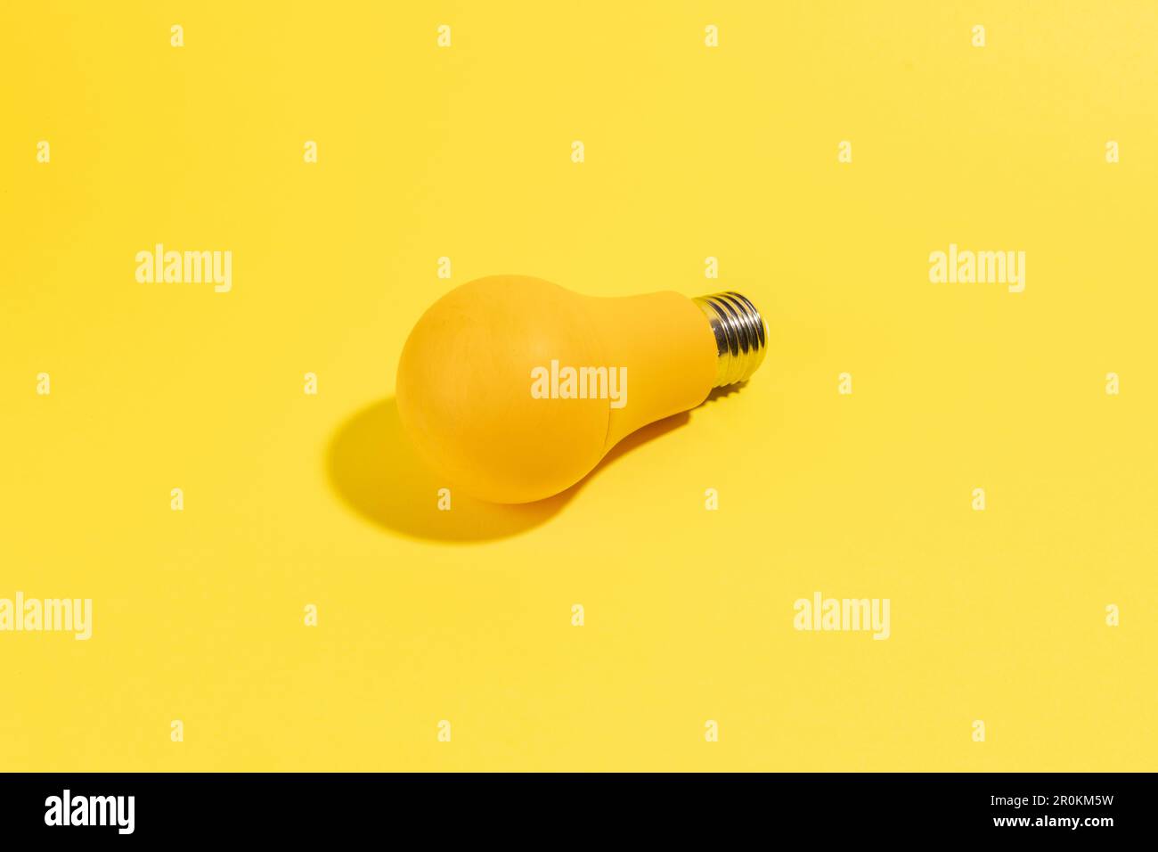 Yellow light bulb on a yellow background minimalist style Stock Photo ...