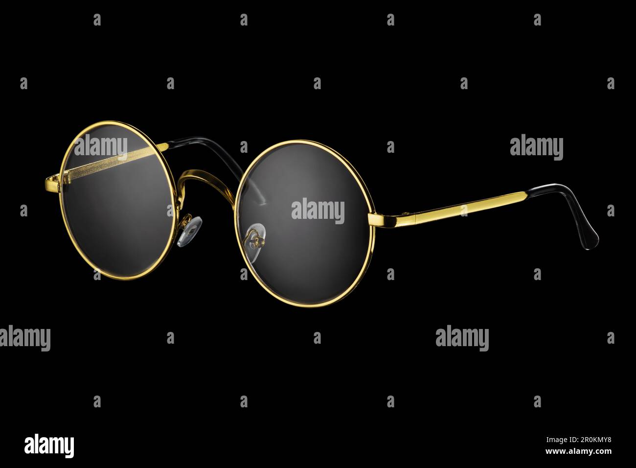 Classic gold frame round glasses isolated on black background Stock ...