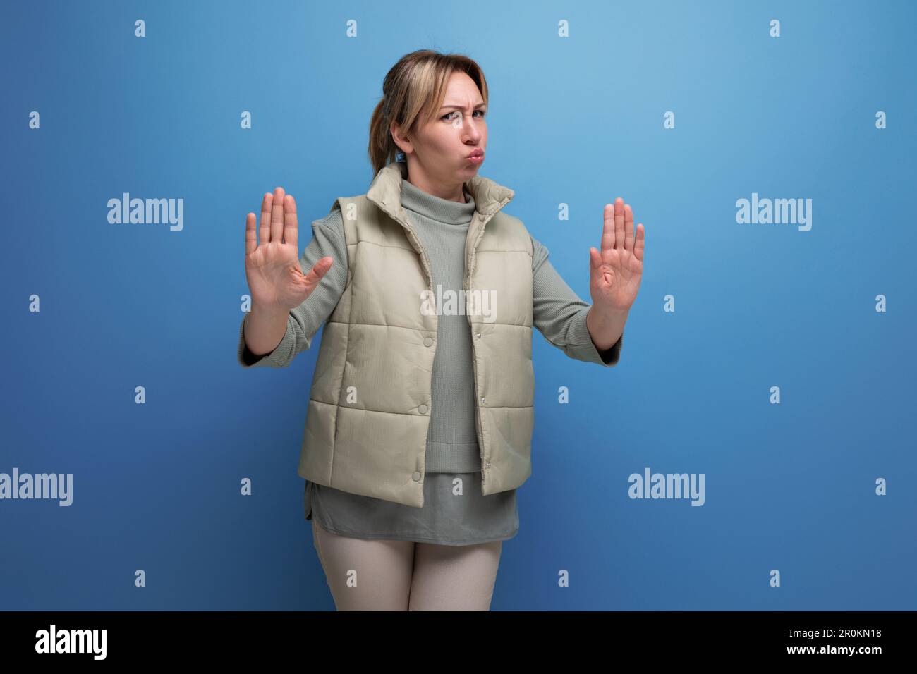 blond young woman showing refusal and disagreement gesture on studio ...