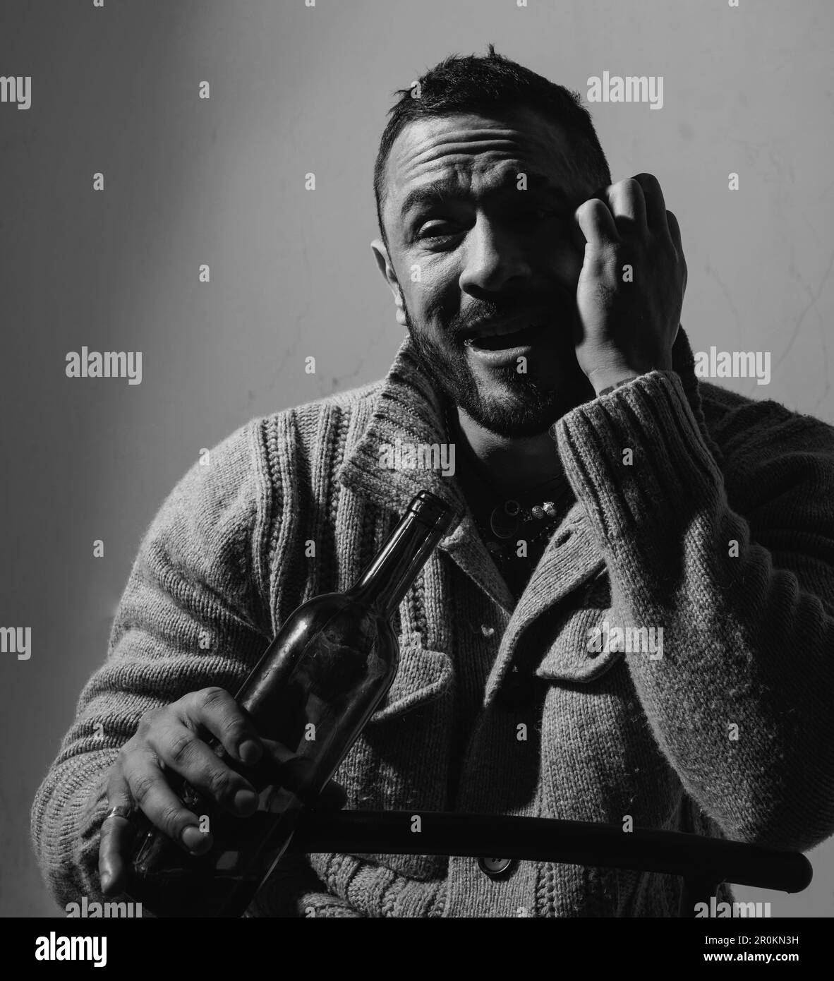 Alcoholic man with bottles wine cry. Depressed crying man. Drunk ...