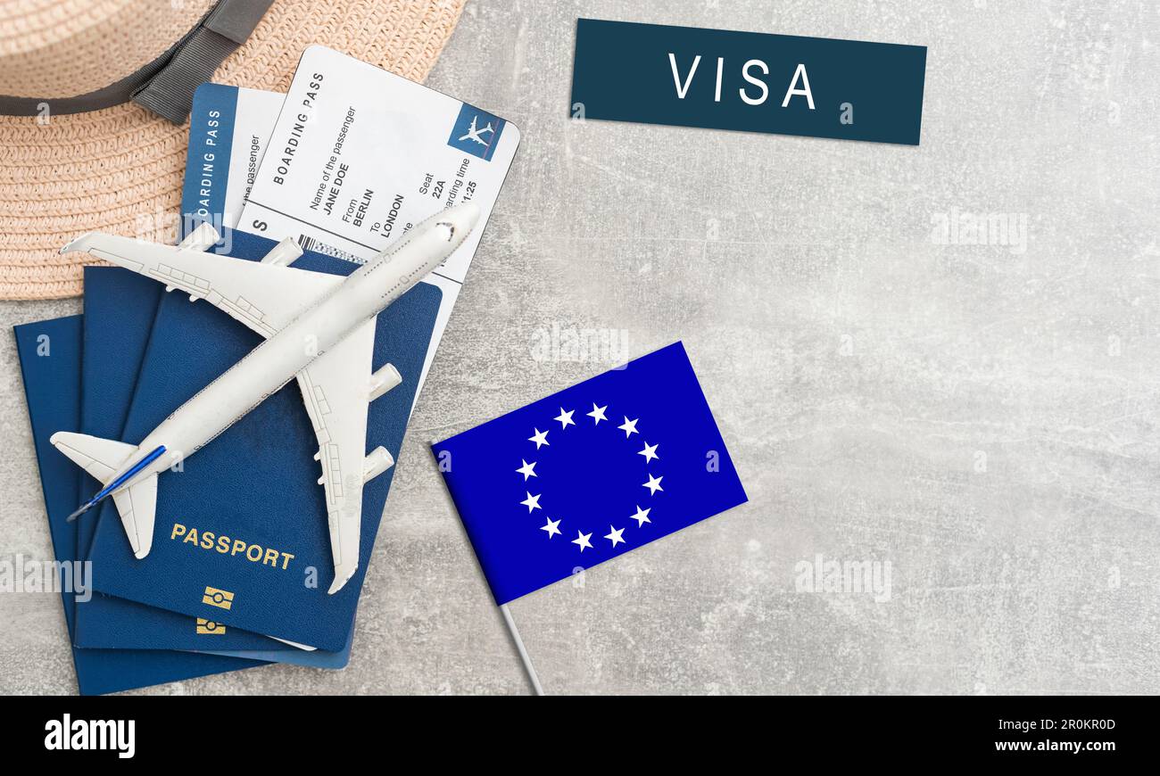 Flag of European Union with passport and toy airplane on wooden ...