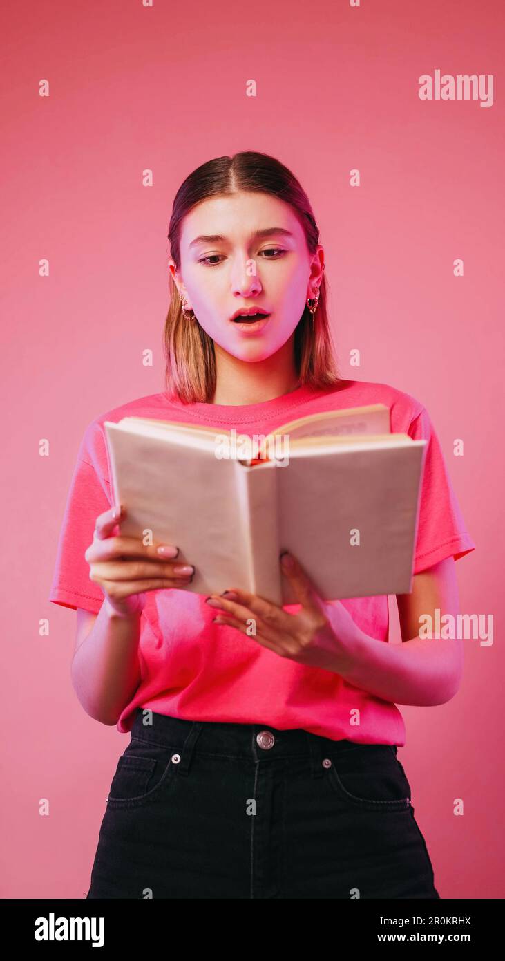 Surprised reading interesting novel admiring girl Stock Photo - Alamy