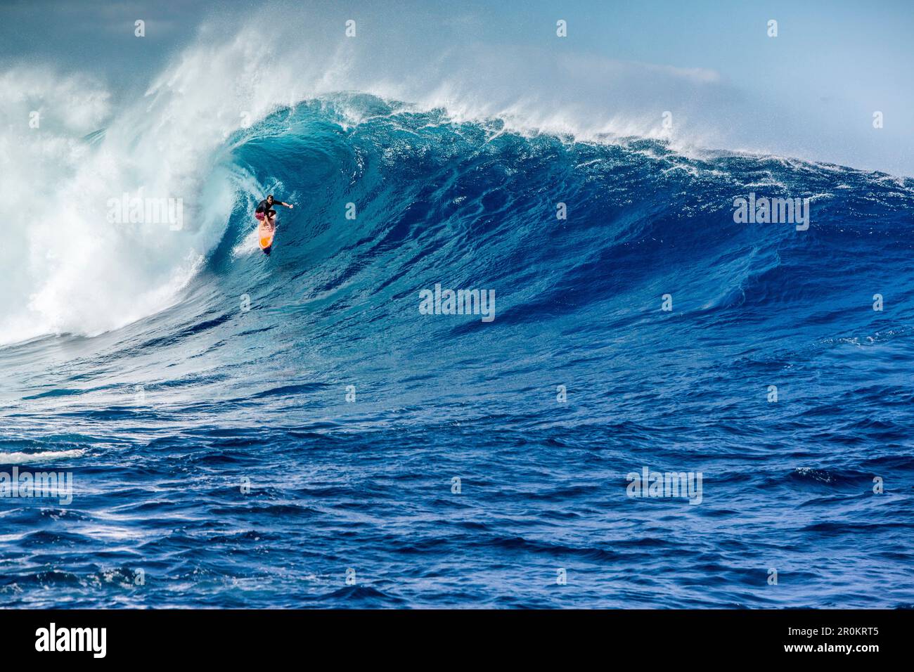 USA, HAWAII, Maui, Jaws, big wave surfers taking off on a wave at Peahi ...