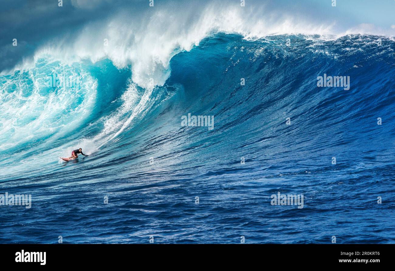 USA, HAWAII, Maui, Jaws, big wave surfers taking off on a wave at Peahi ...