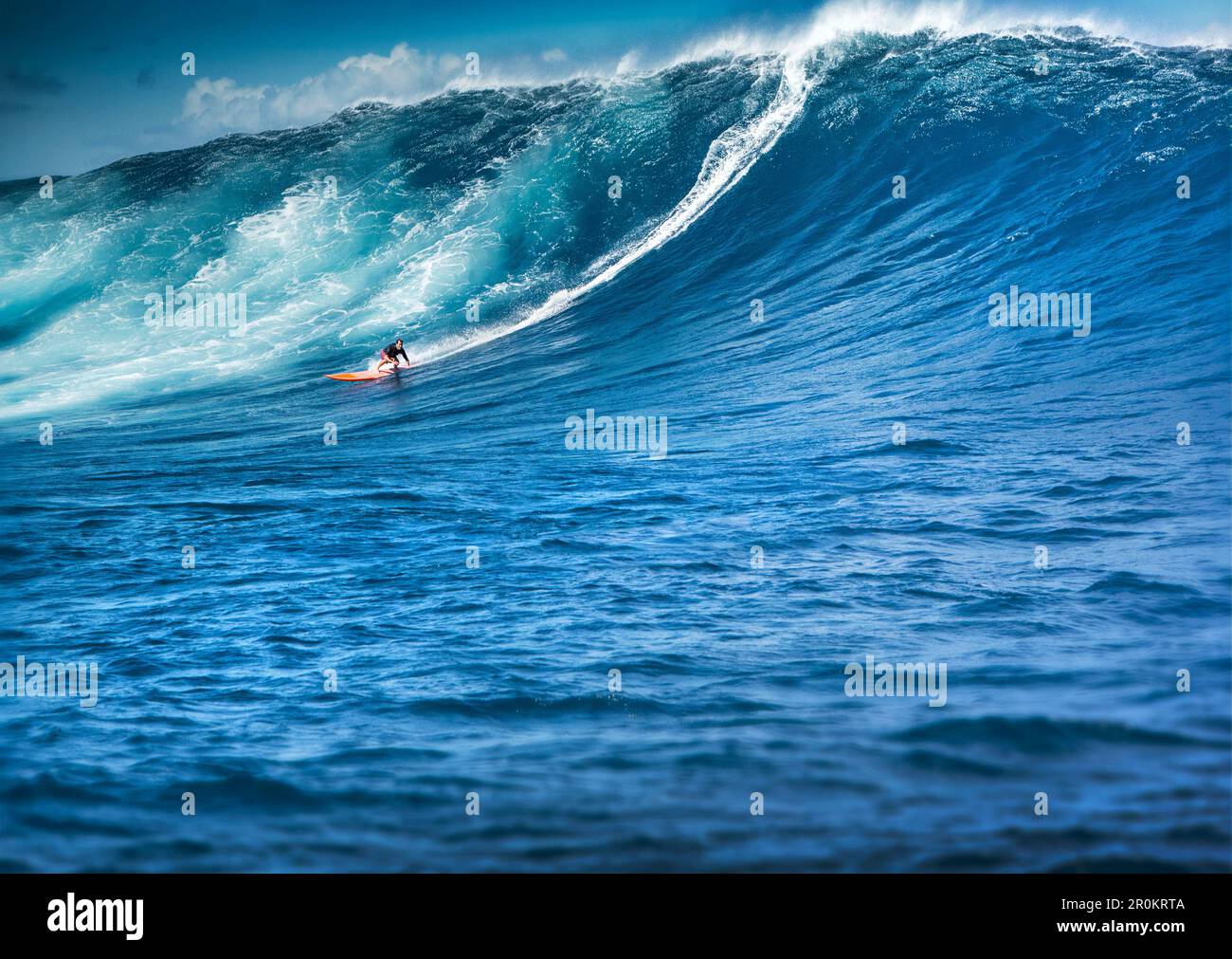 USA, HAWAII, Maui, Jaws, big wave surfers taking off on a wave at Peahi ...
