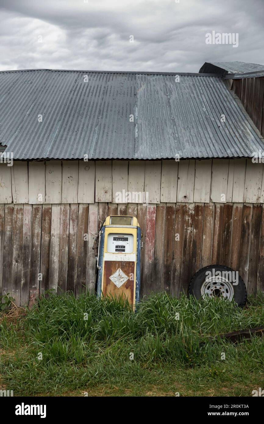 USA, Oregon, Enterprise, an old gas pump leans up against the side of a ...