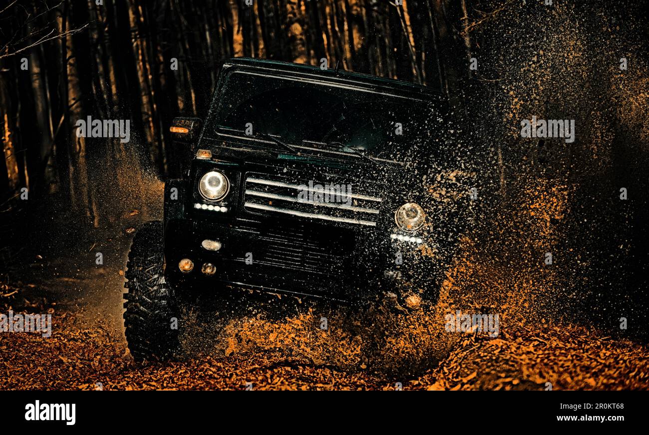 Mud and water splash in off-road racing. Off-road vehicle goes on the ...