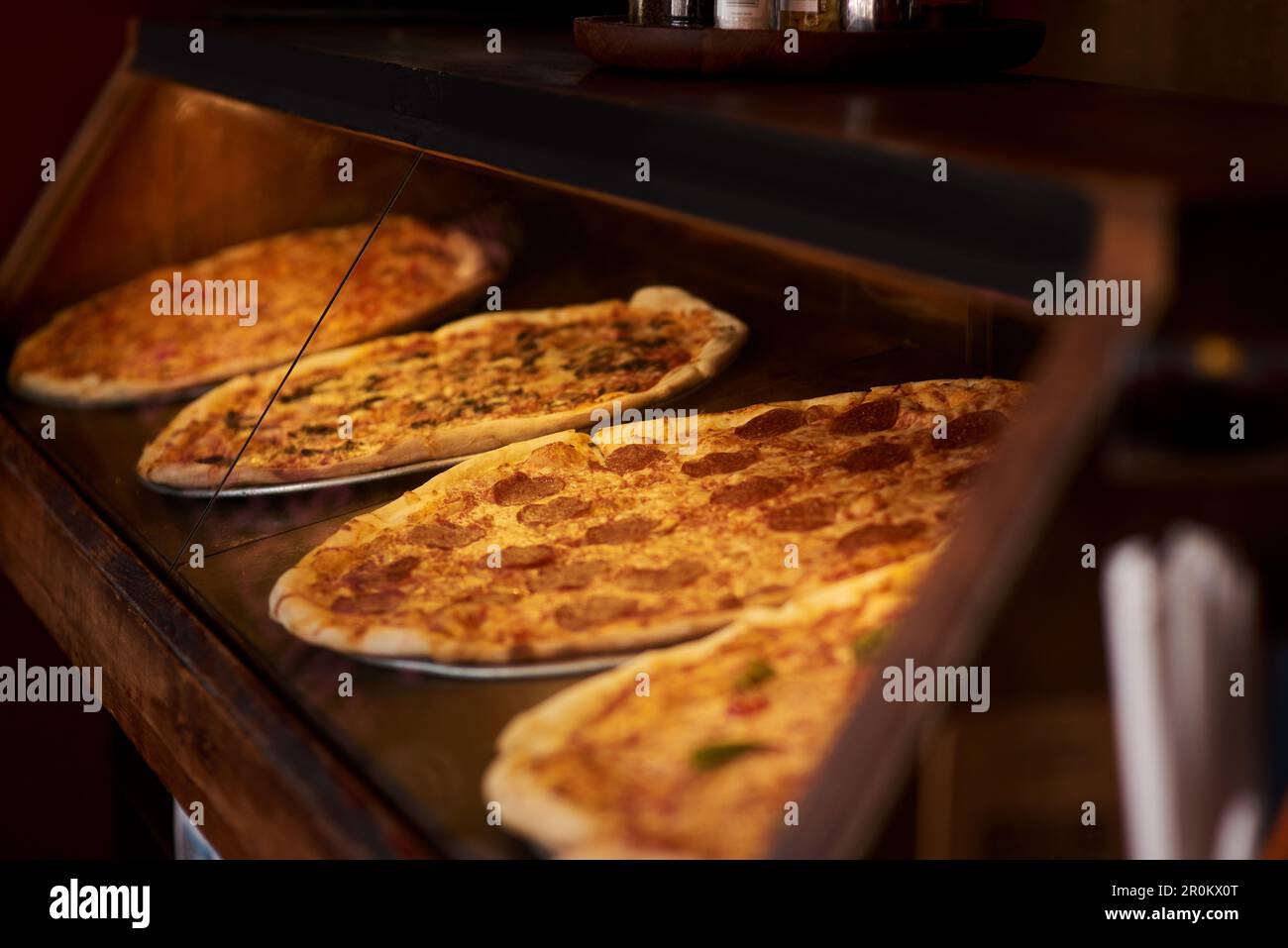 We have a variety to choose from. Closeup shot of pizza on display in a ...