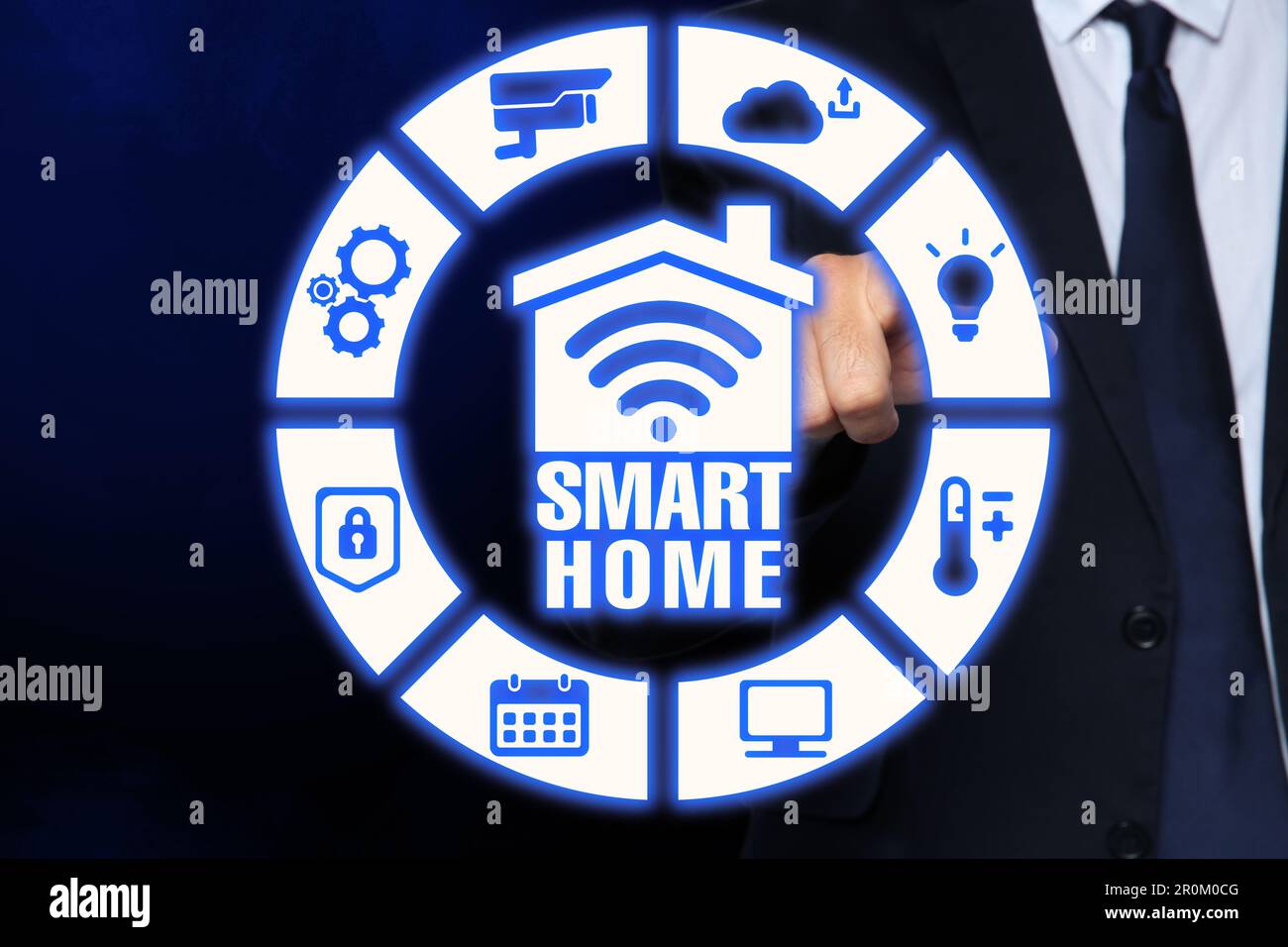Man using digital screen with Smart Home interface on dark blue ...