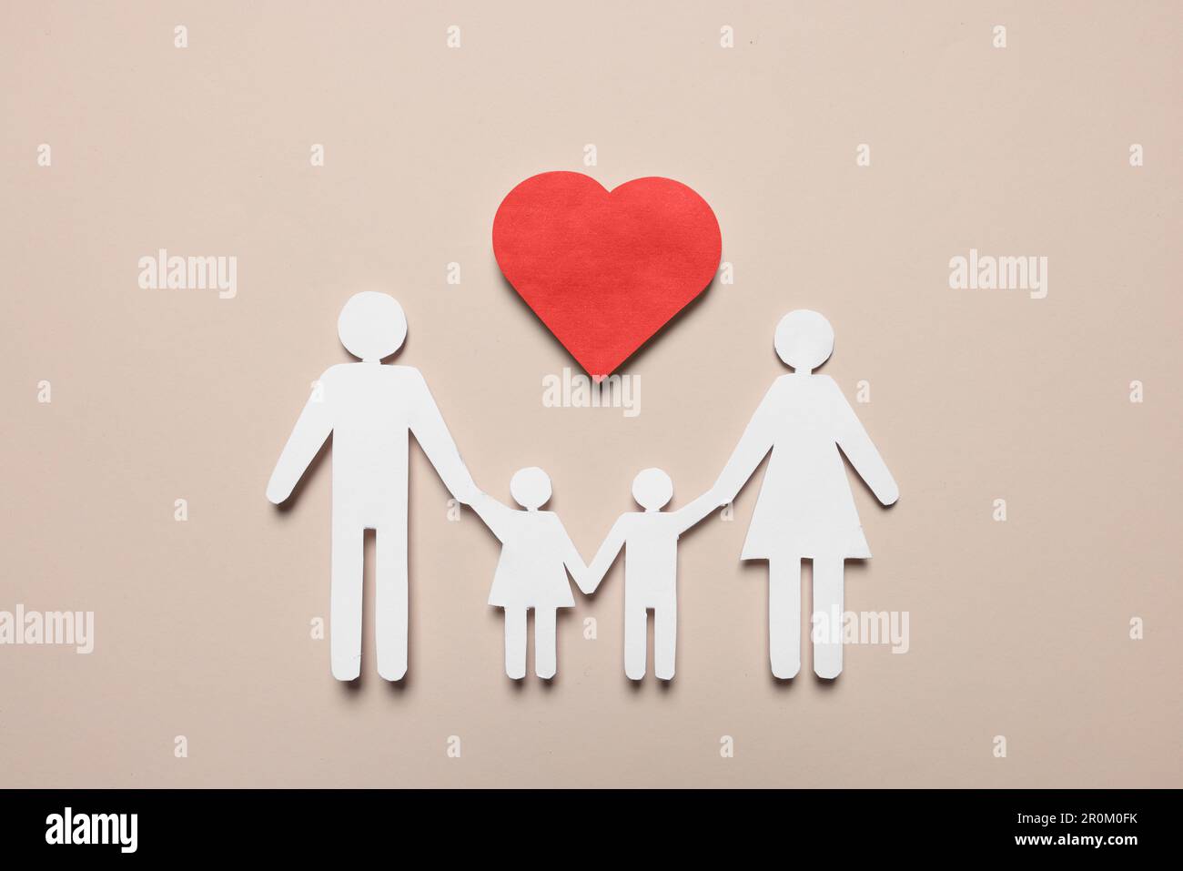 Paper family figures and red heart on beige background, flat lay ...