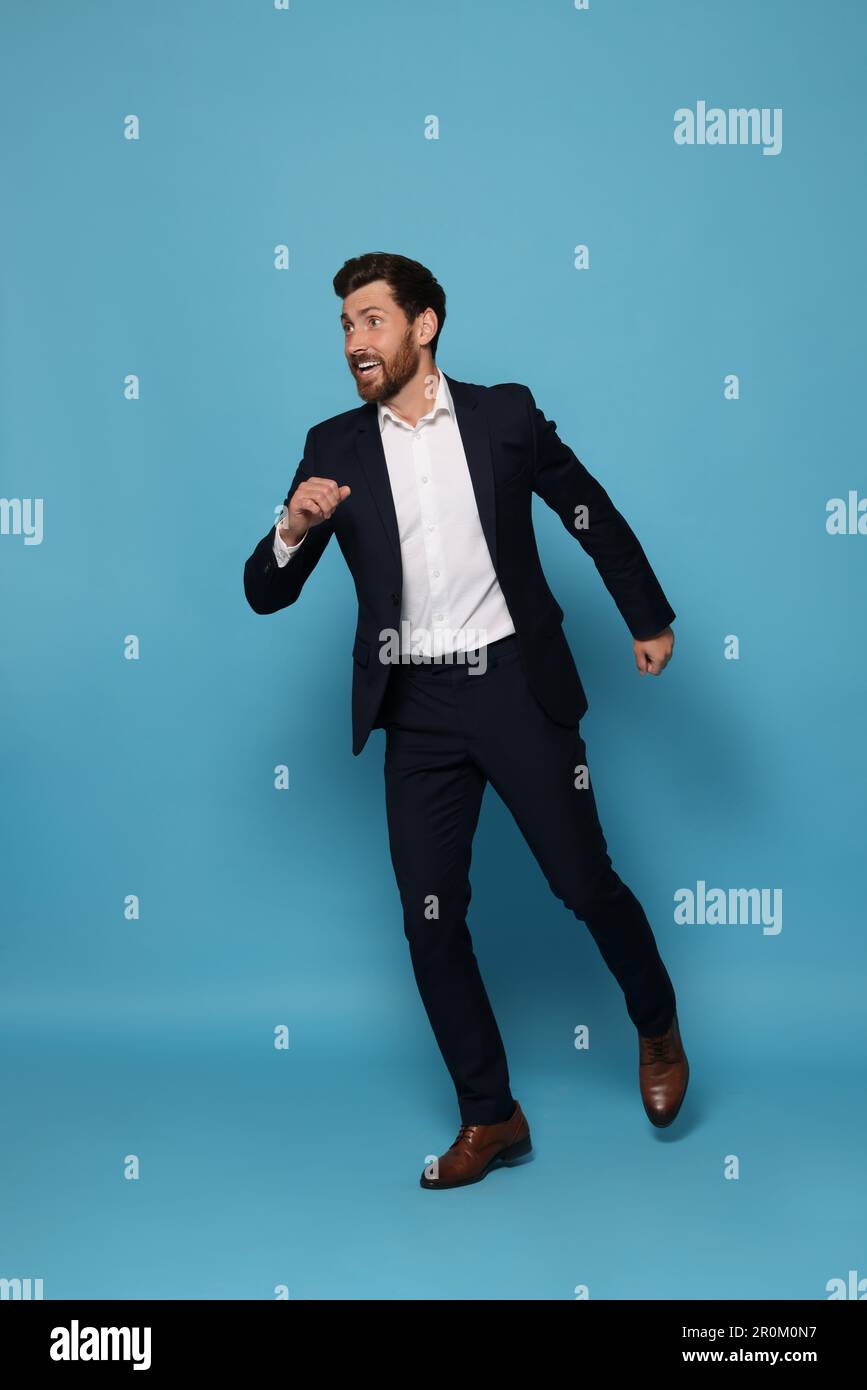 Man in suit running hi-res stock photography and images - Alamy