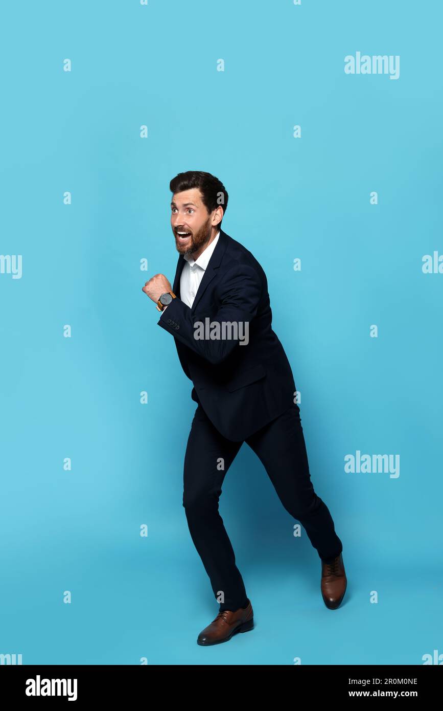 Man in suit running hi-res stock photography and images - Alamy