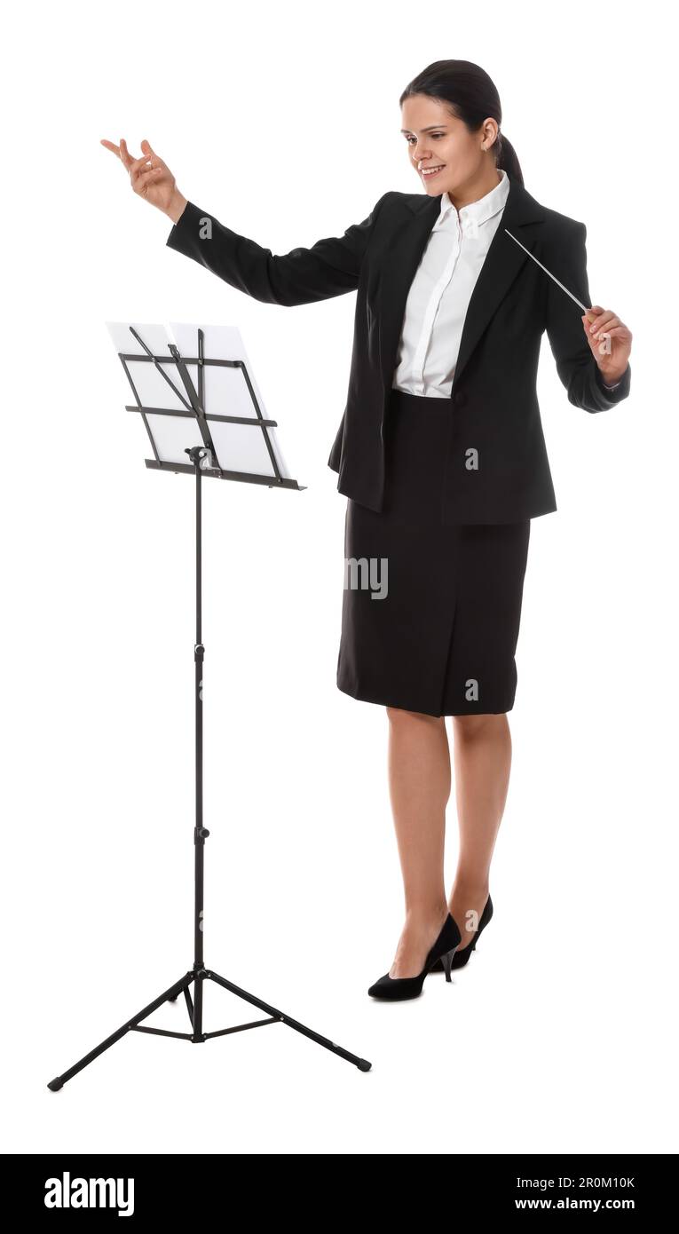 Happy young conductor with baton and note stand on white background ...
