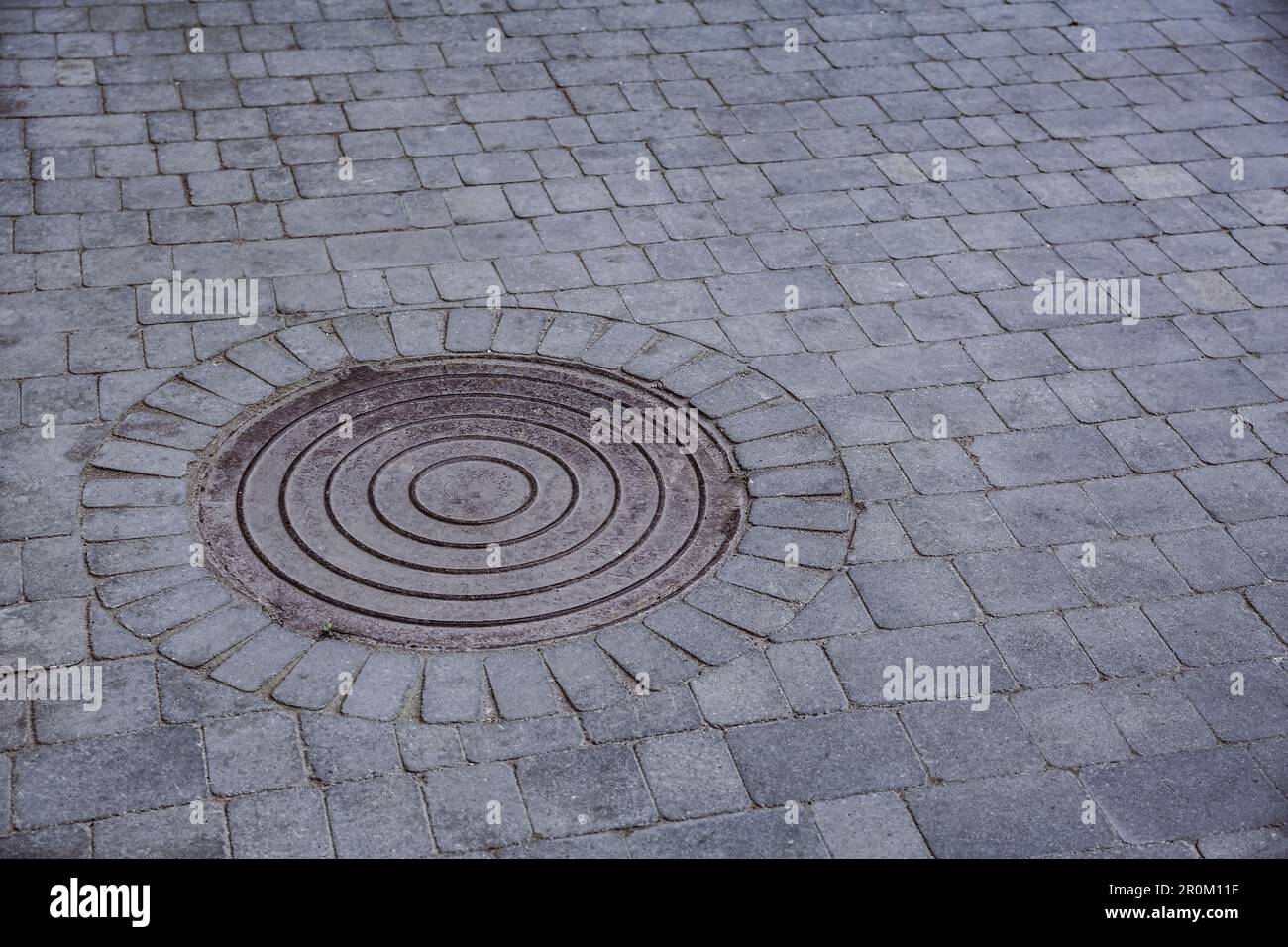 Metal sewer hatch on street tiles outdoors, space for text Stock Photo ...