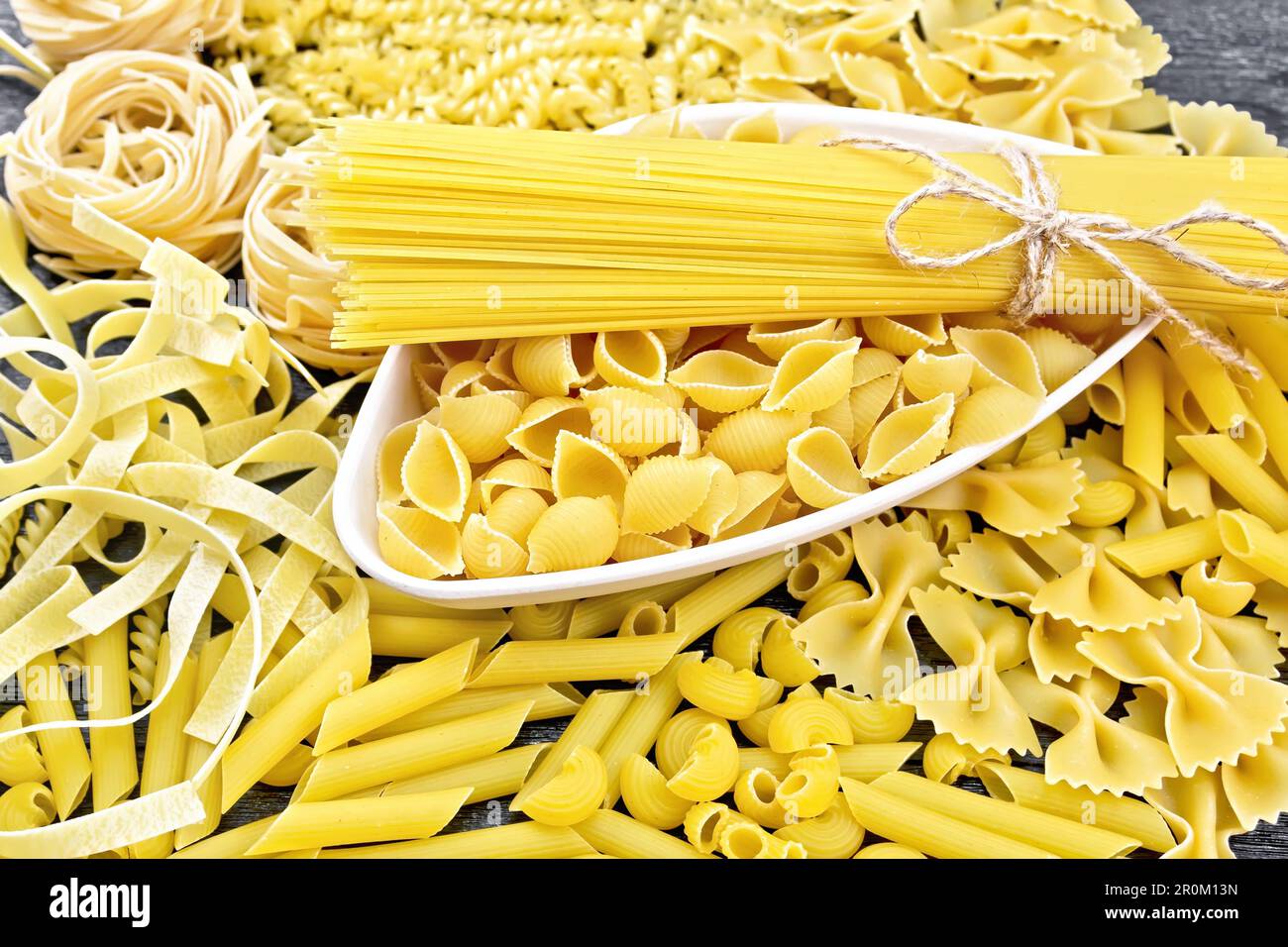 Pasta seashells and spaghetti in a bowl, pipe rigate, tagliatelle ...