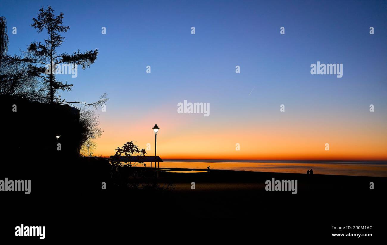 This stunning image captures a vibrant sunset sky reflecting over a ...