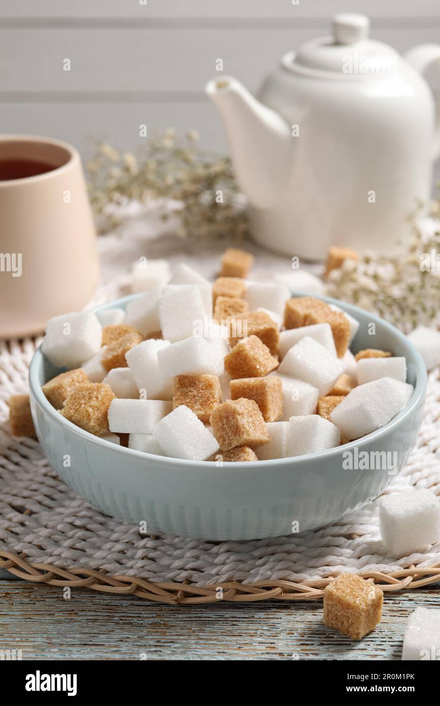 Different refined sugar cubes in bowl on rustic table Stock Photo - Alamy
