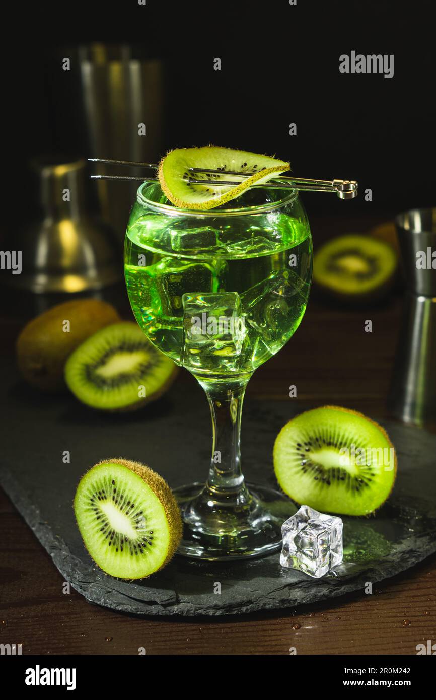 Summer cold drink and beverages. Alcohol coctail with kiwi and ice in ...