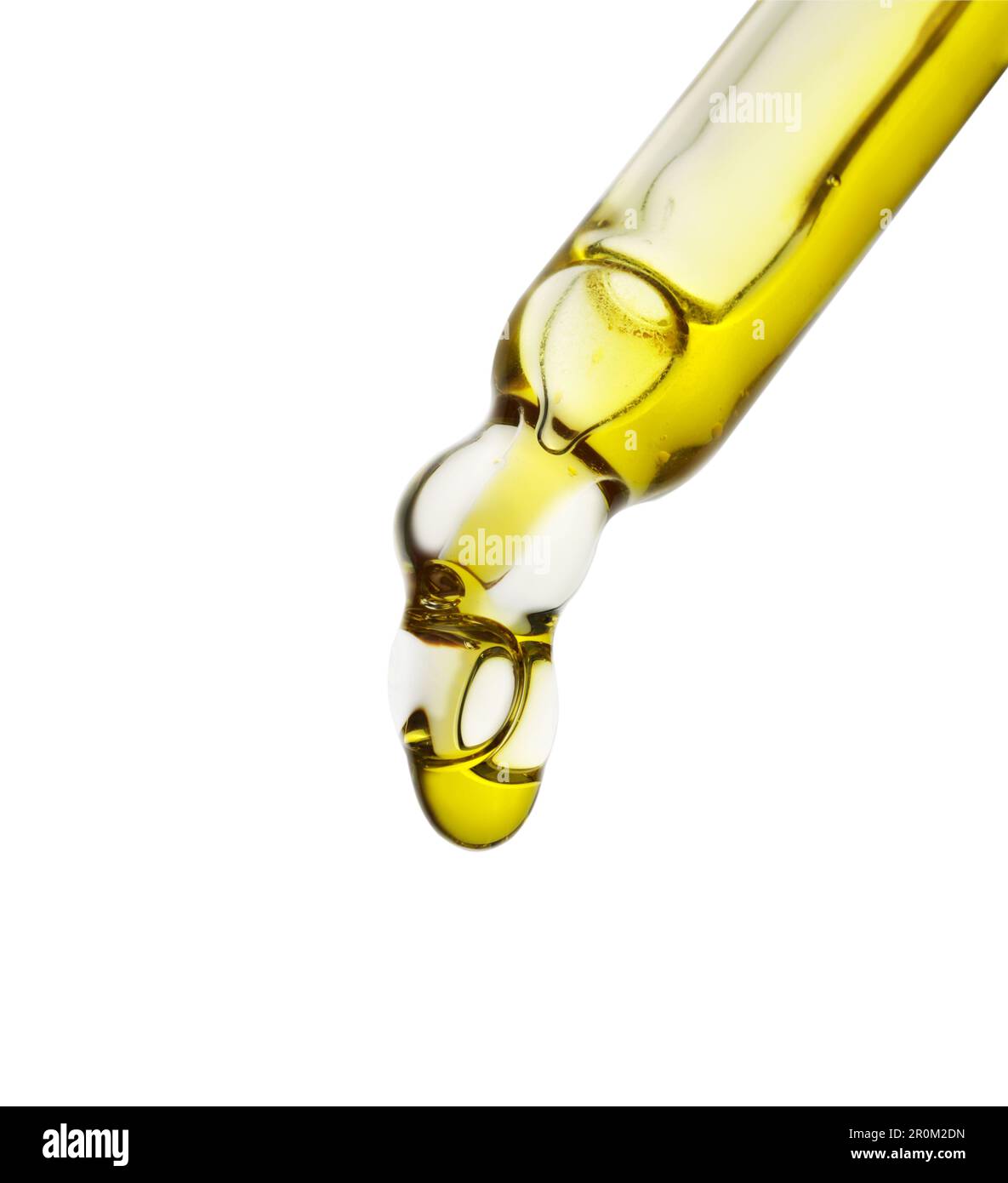 Dripping yellow facial serum from pipette on white background, closeup ...